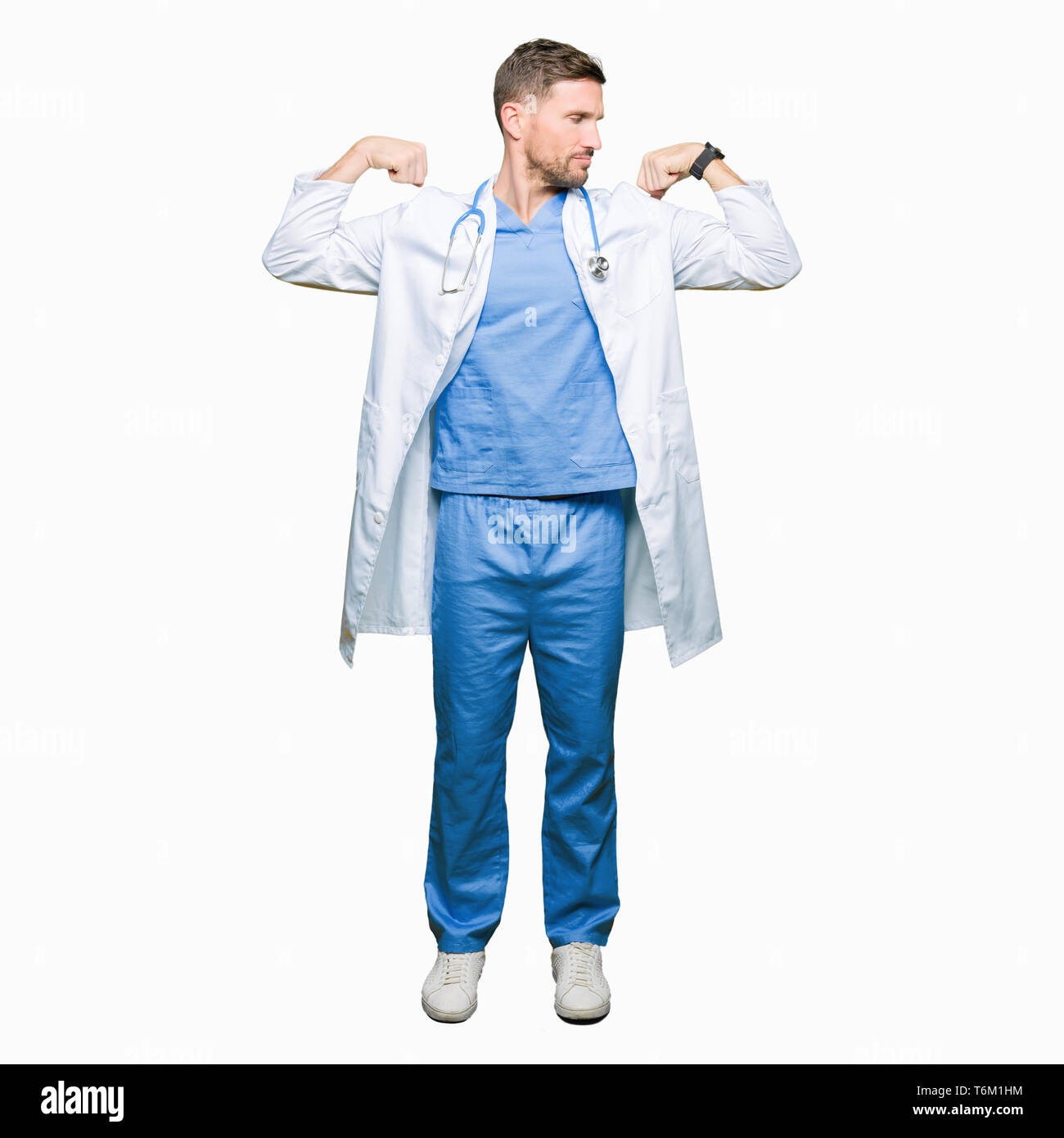 Handsome doctor man wearing medical uniform over isolated background ...