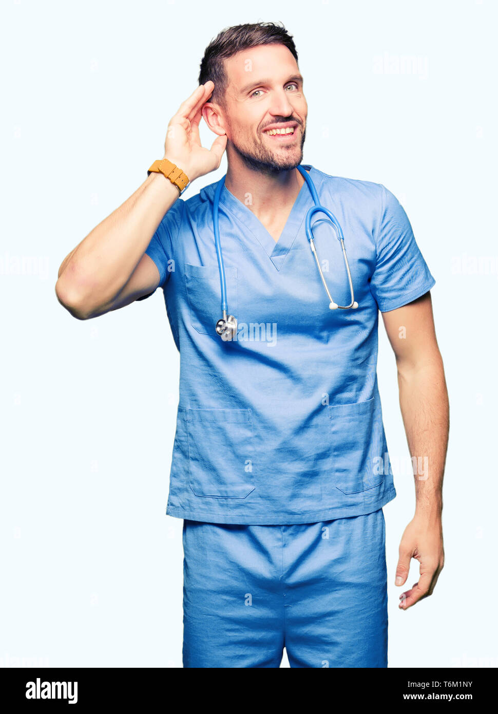 Handsome doctor man wearing medical uniform over isolated background ...