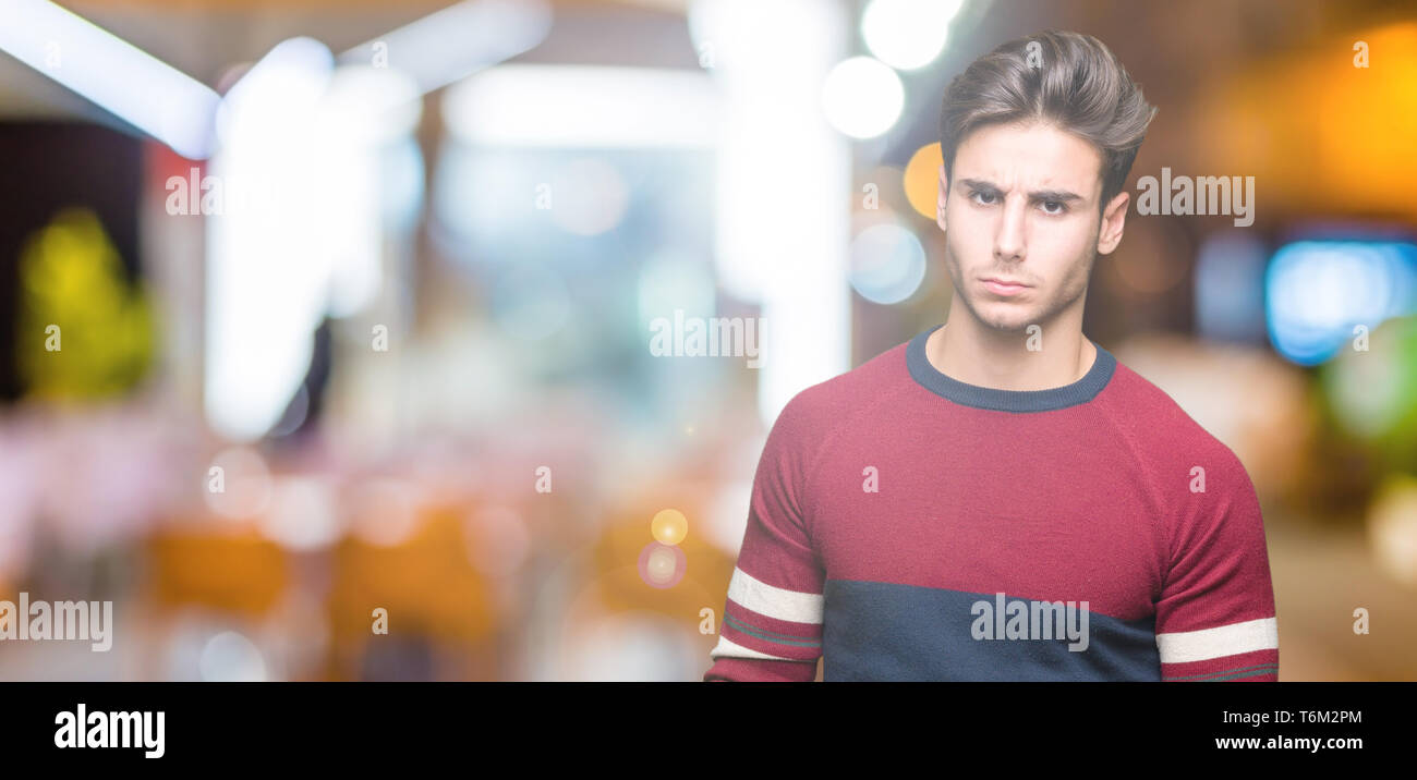 Young handsome man over isolated background skeptic and nervous ...