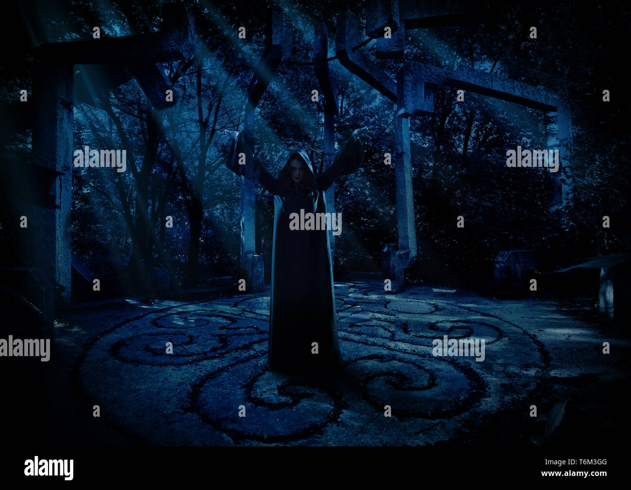 Witch in the ruins in night forest Stock Photo - Alamy