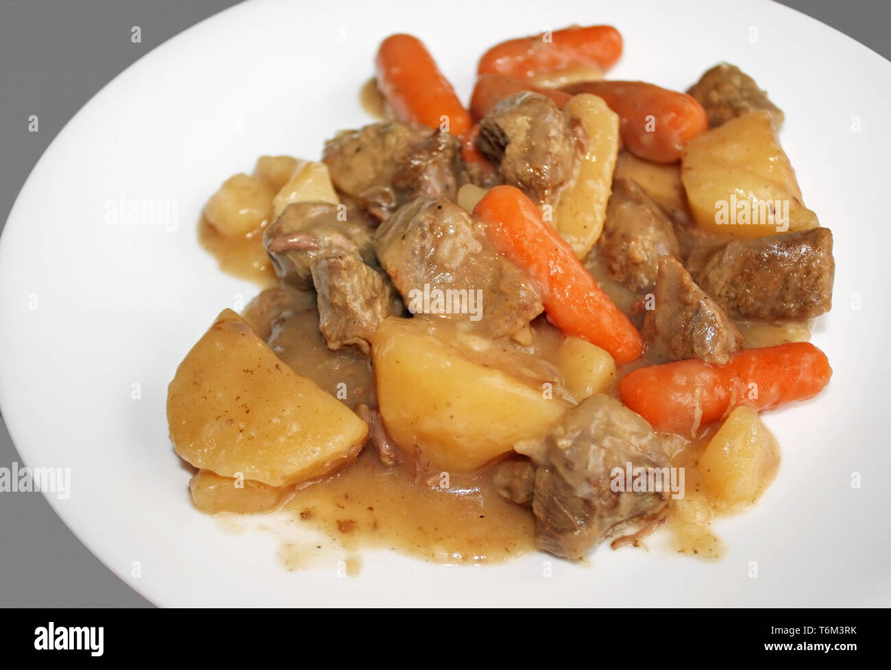 Plate of delicious homemade beef stew. With beef, carrots and potatoes ...