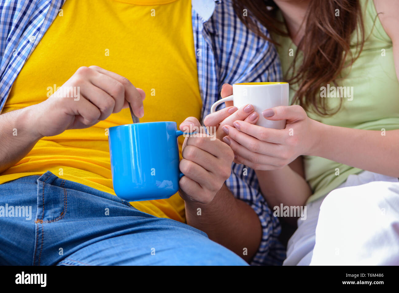 The young couple drinking tea or coffee together Stock Photo - Alamy