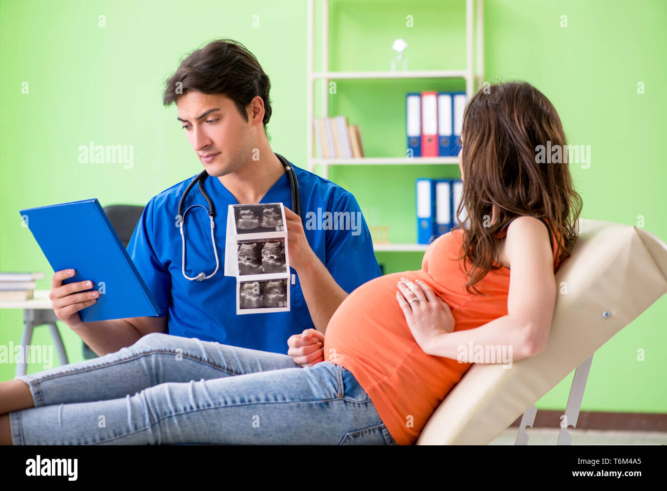 The pregnant woman visiting male gynecologyst at the clinic Stock Photo ...