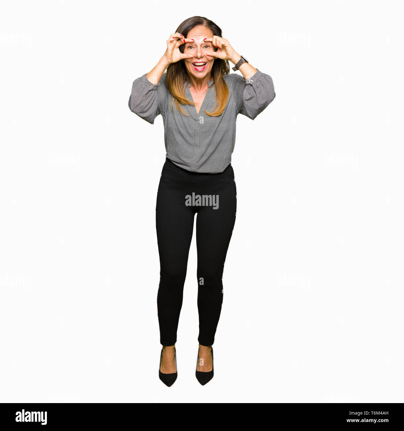 Beautiful middle age business woman Trying to open eyes with fingers ...