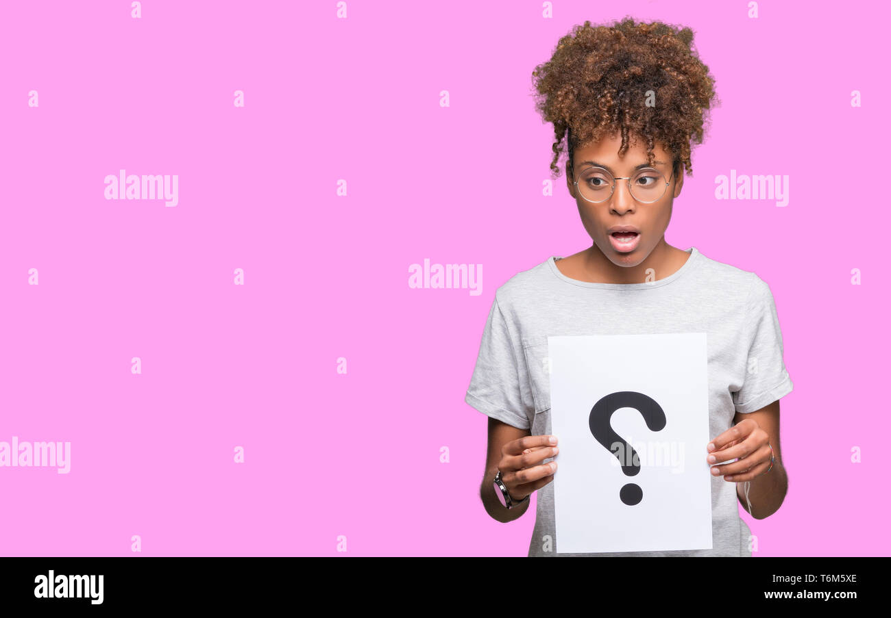 Young african american woman holding paper with question mark over ...