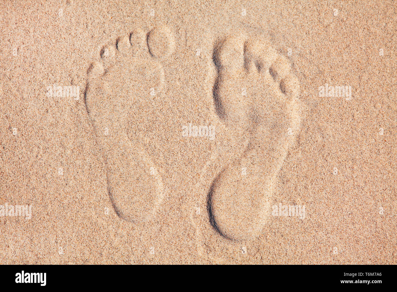 Two Footprints in sand at the Beach Stock Photo - Alamy