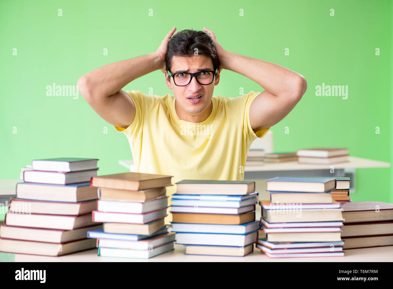 Student with too many books to read before exam Stock Photo - Alamy