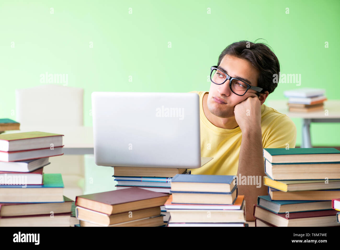 Student with too many books to read before exam Stock Photo - Alamy