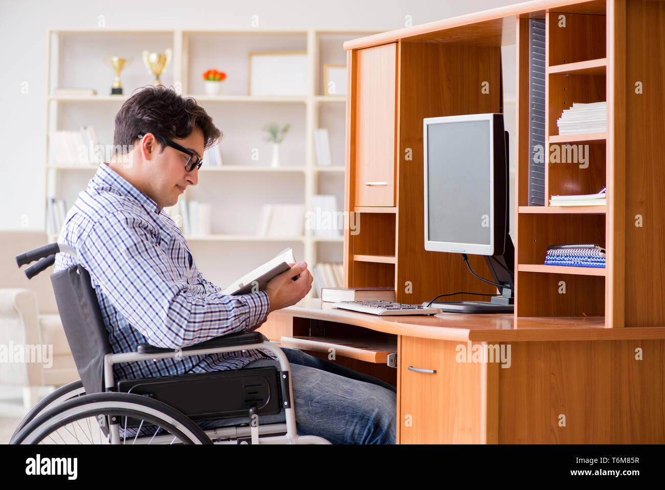 Disabled student studying at home on wheelchair Stock Photo - Alamy