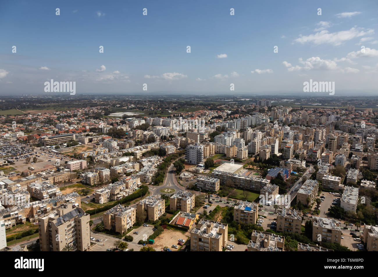Aerial view of a residential neighborhood in a city during a cloudy and sunny day. Taken in ...