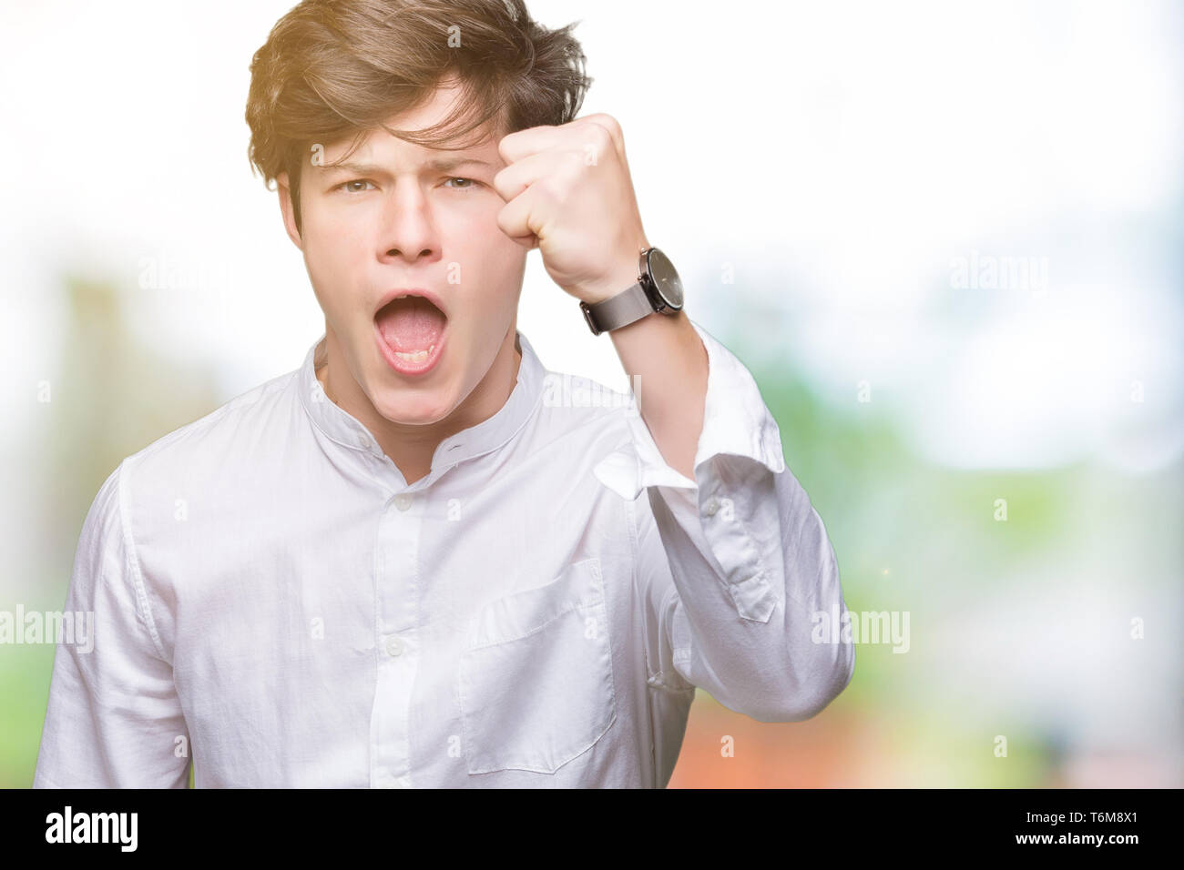 Young handsome business man over isolated background angry and mad ...