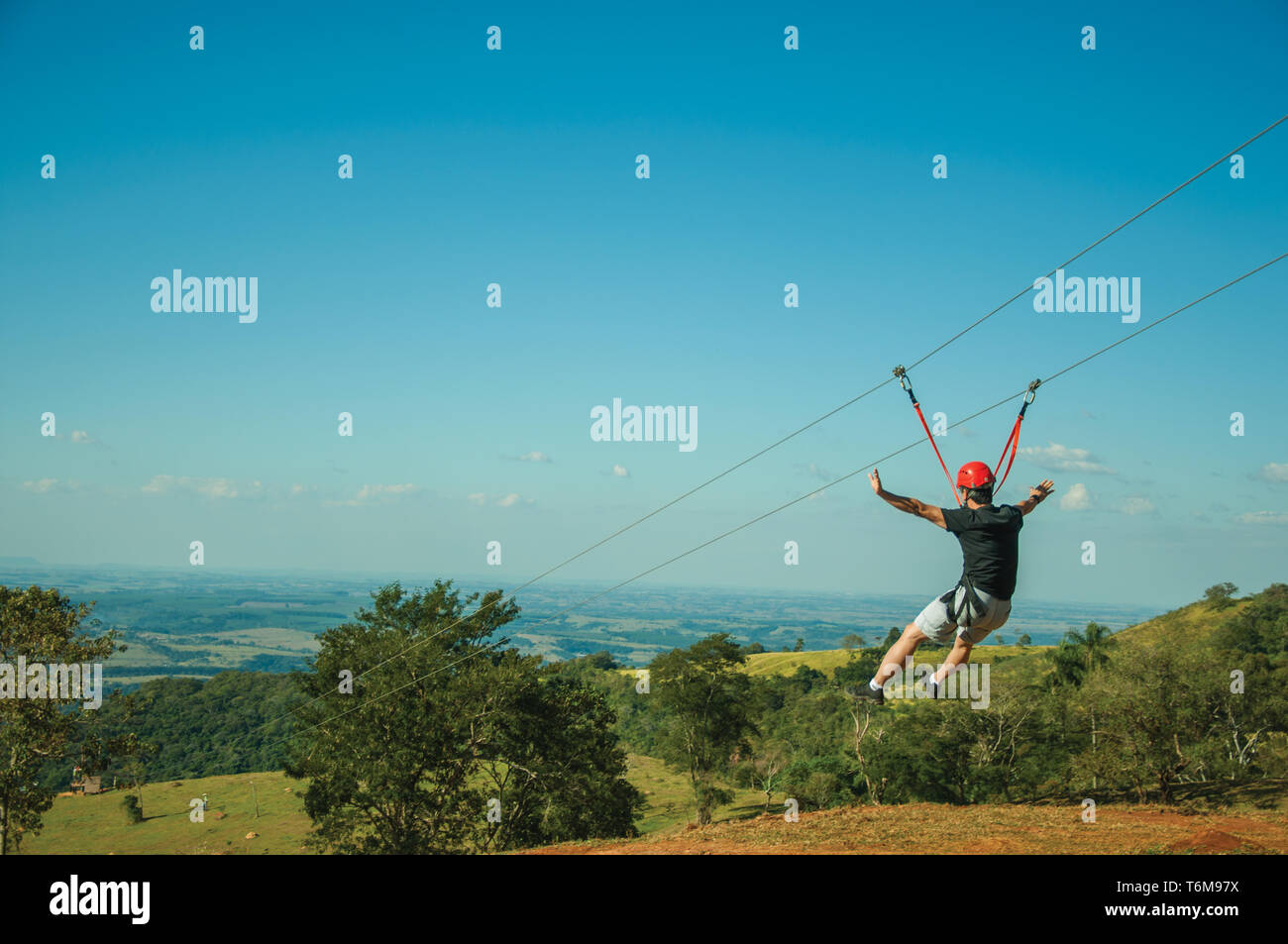 Pardinho, Brazil - May 31, 2018. Man descending by cables in a sport ...