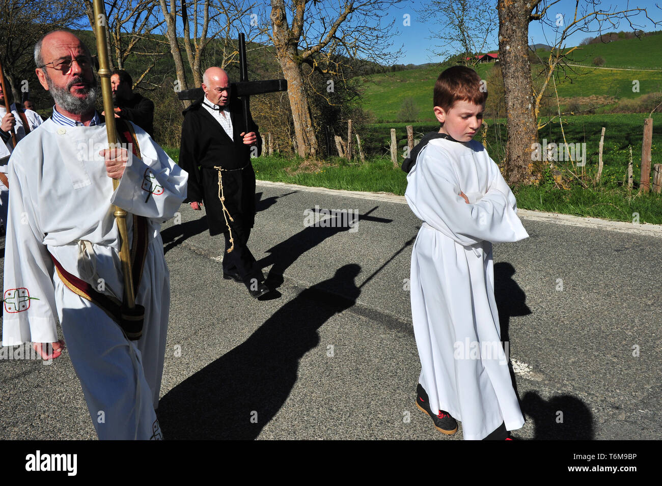 A child altar boy seen accompanying the procession's entourage during ...
