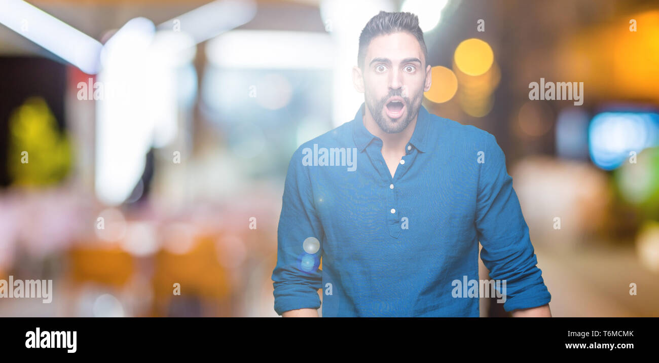 Young handsome man over isolated background In shock face, looking ...