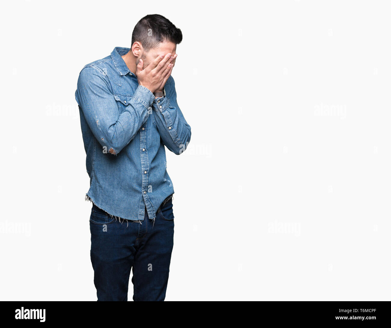 Young handsome man over isolated background with sad expression ...