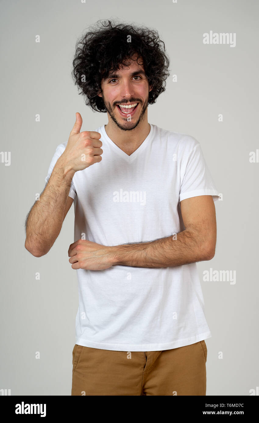 Close up portrait of young caucasian man smiling and doing OK sign ...