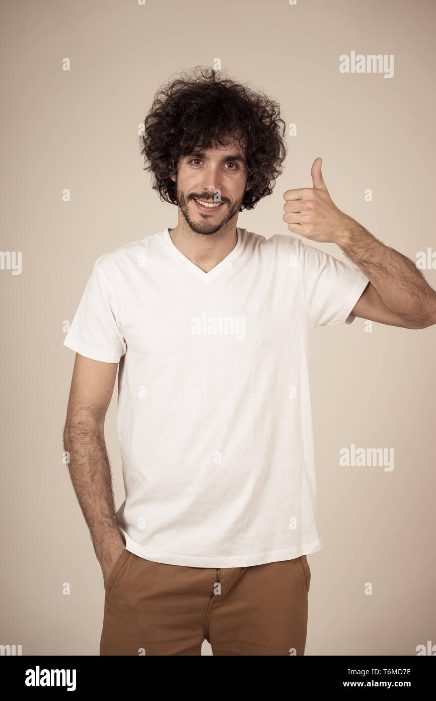 Close up portrait of young caucasian man smiling and doing OK sign ...
