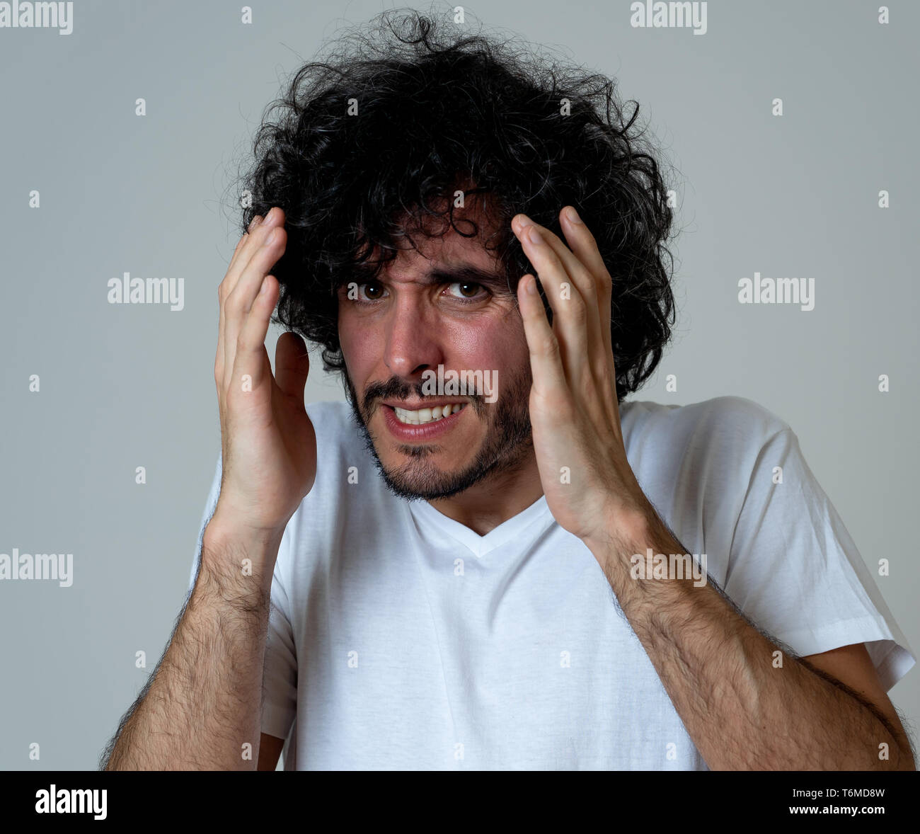 Portrait of young man in shock with scared face making frightened ...