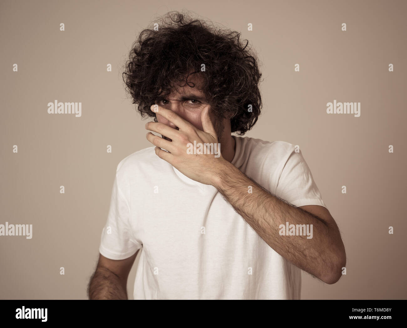 Portrait of young man in shock with scared face making frightened ...