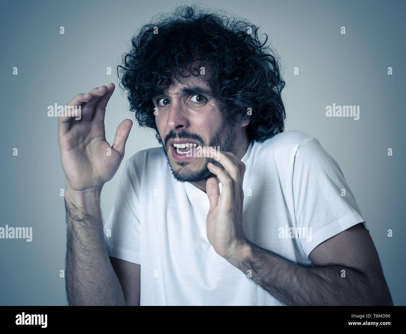 Portrait of young man in shock with scared face making frightened ...