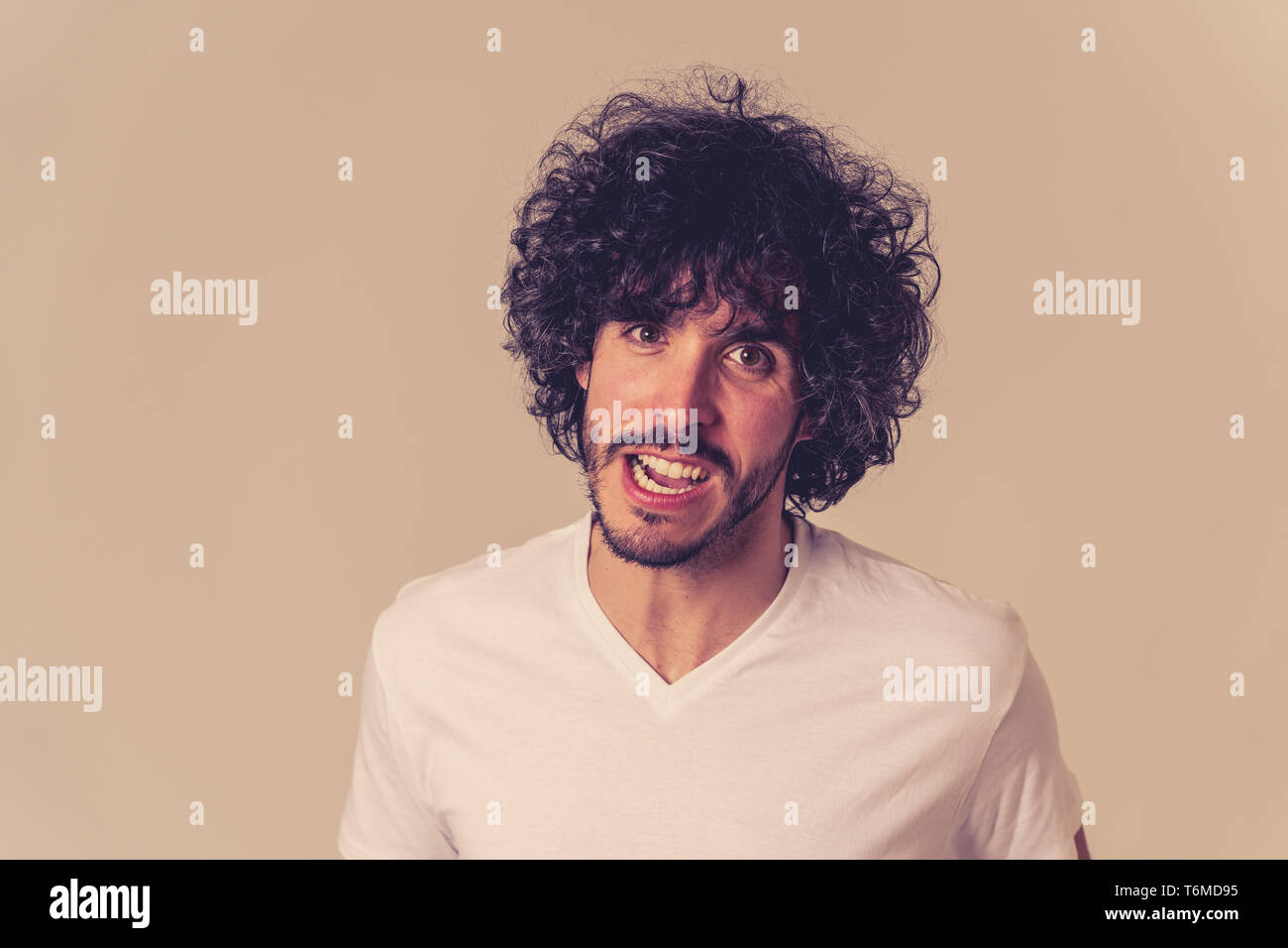 Annoyed young millennial man with an angry face looking mad and furious ...