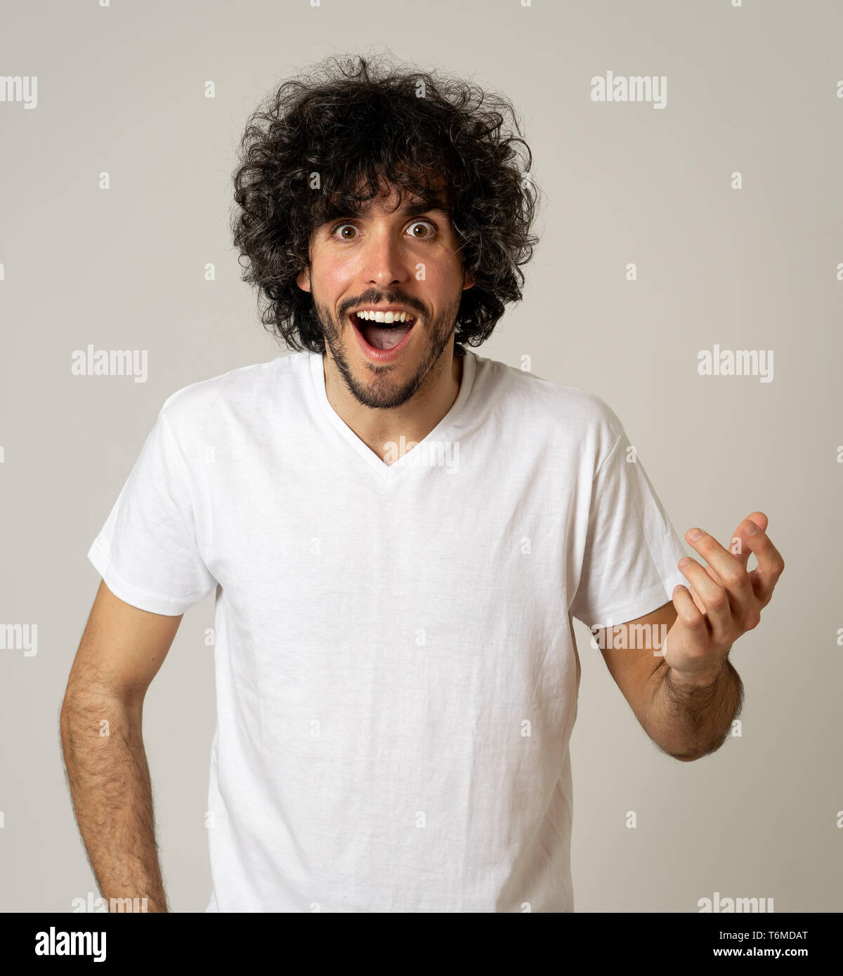 Portrait of funny attractive young man with happy and surprised face ...