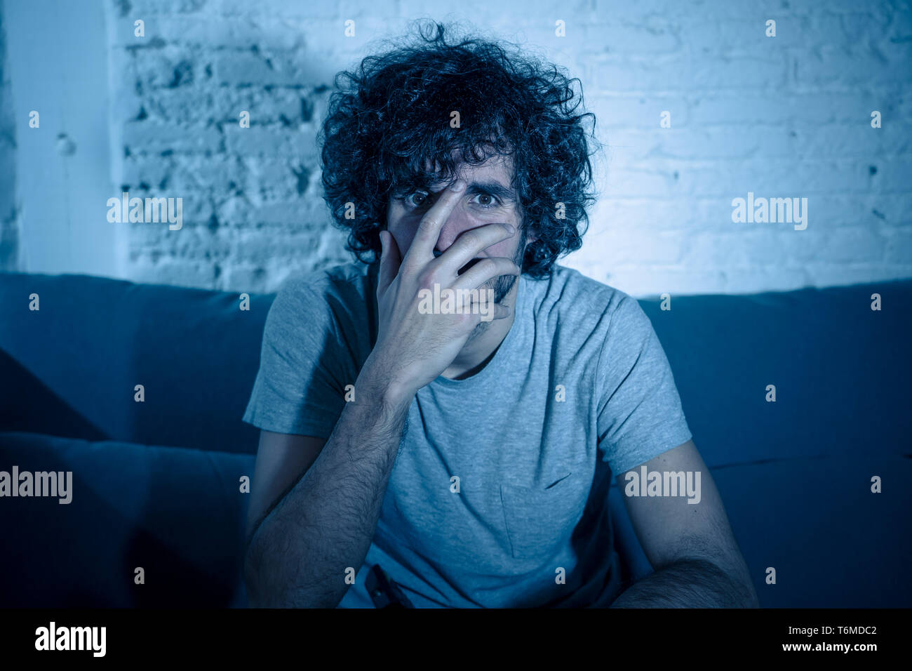 Lifestyle portrait of young man feeling scared and shocked making fear ...