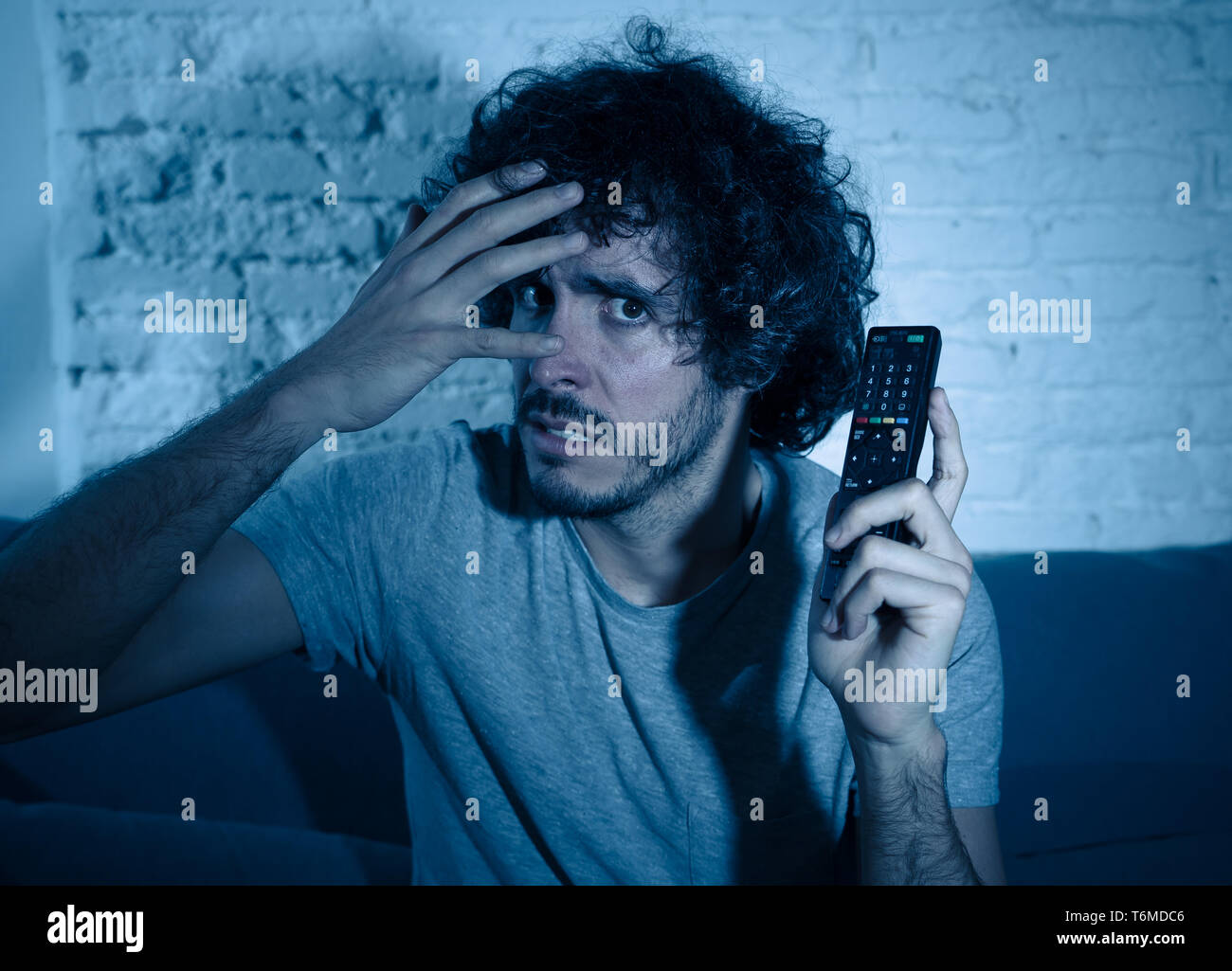 Lifestyle portrait of young man feeling scared and shocked making fear ...