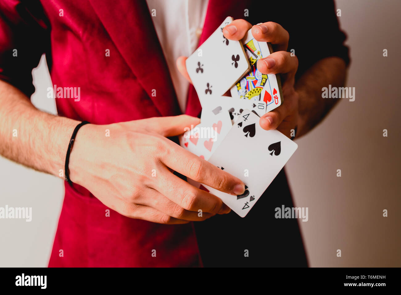 Young magician juggling a deck of playing cards Stock Photo - Alamy