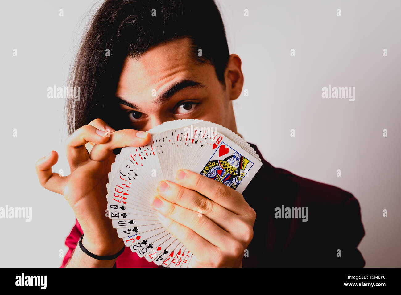 magician doing tricks with a deck of cards Stock Photo - Alamy