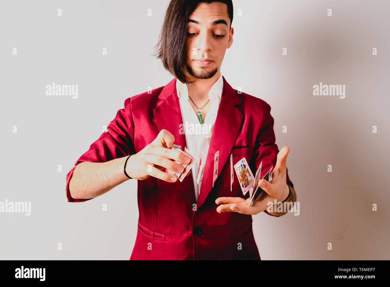 magician doing tricks with a deck of cards Stock Photo - Alamy