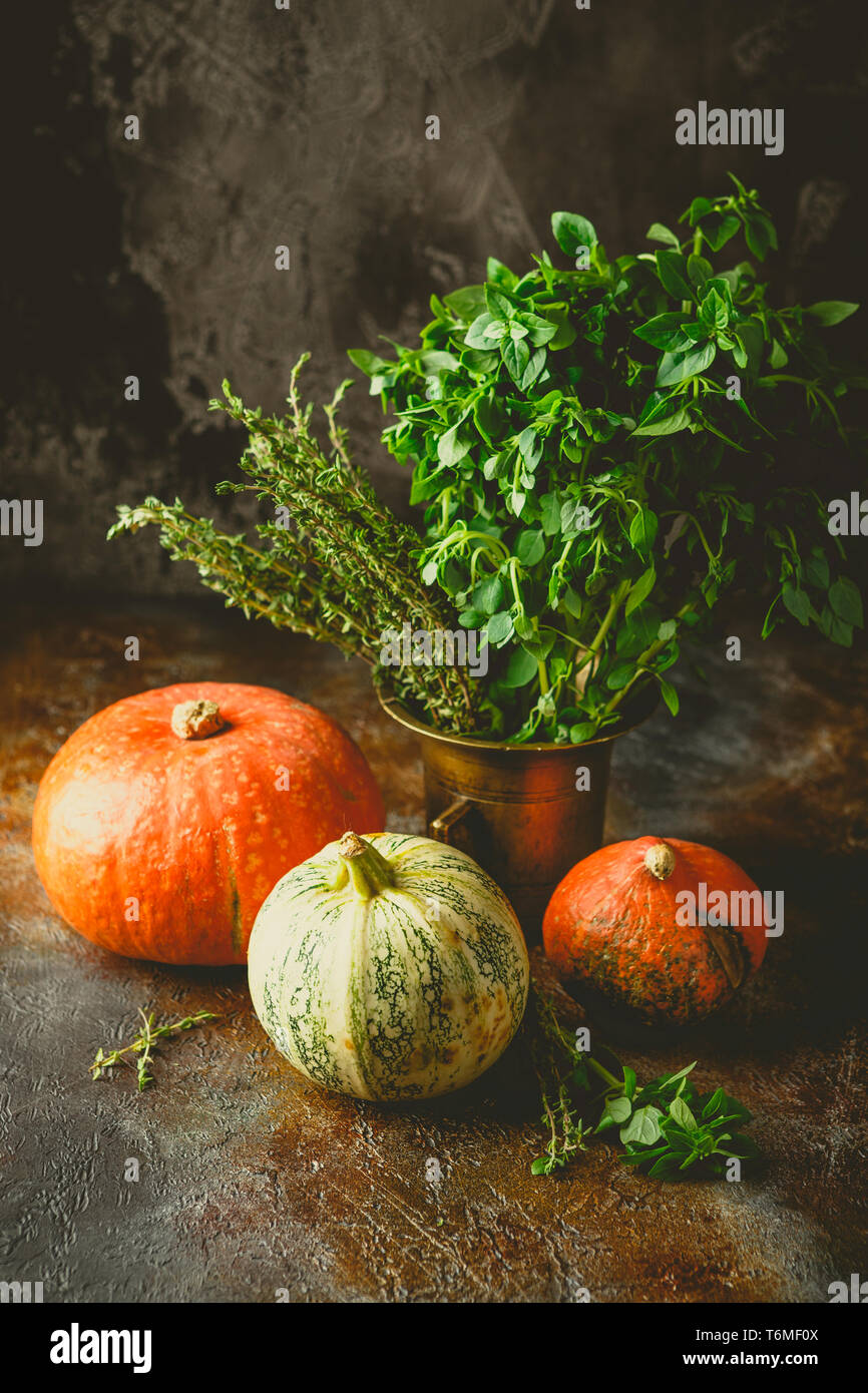 Pumpkin, basil and thyme on a rusty background Stock Photo - Alamy