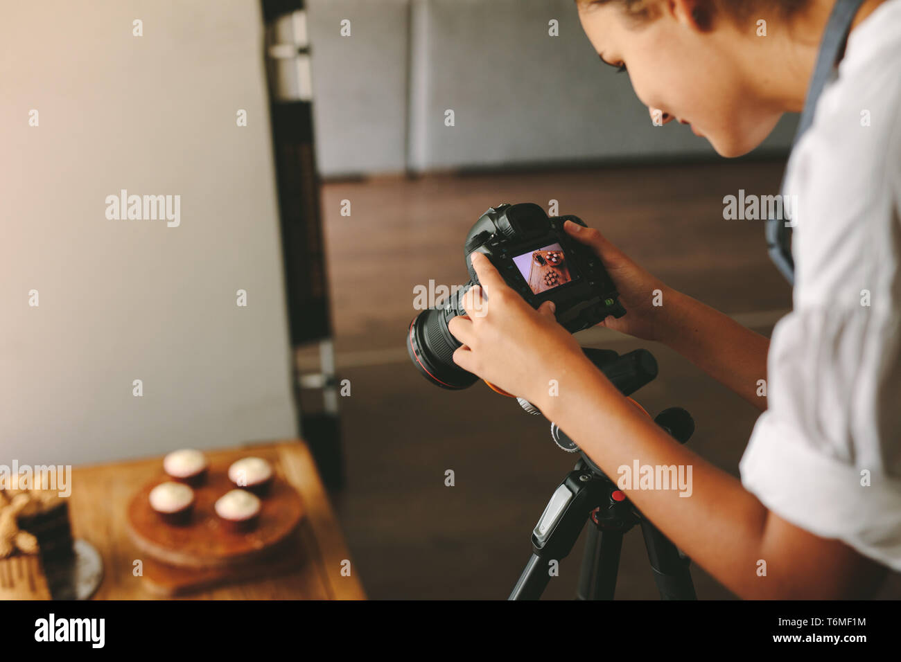 Female chef taking photos for her food blog with digital camera in the ...