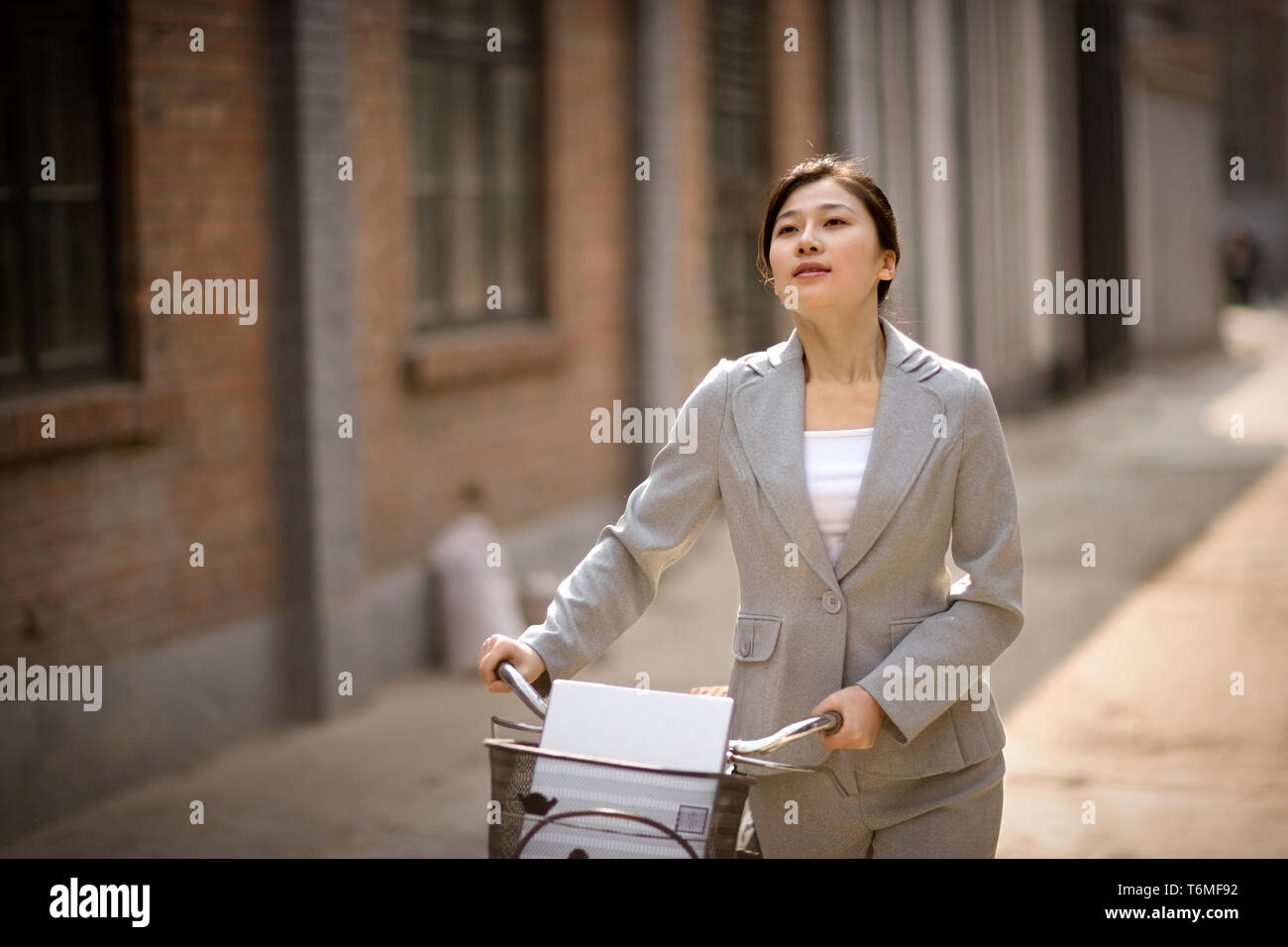 Lady pushing bicycle hi-res stock photography and images - Alamy