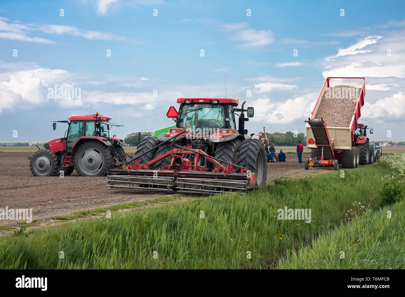 Farmers with tractors having a break at their land Stock Photo - Alamy