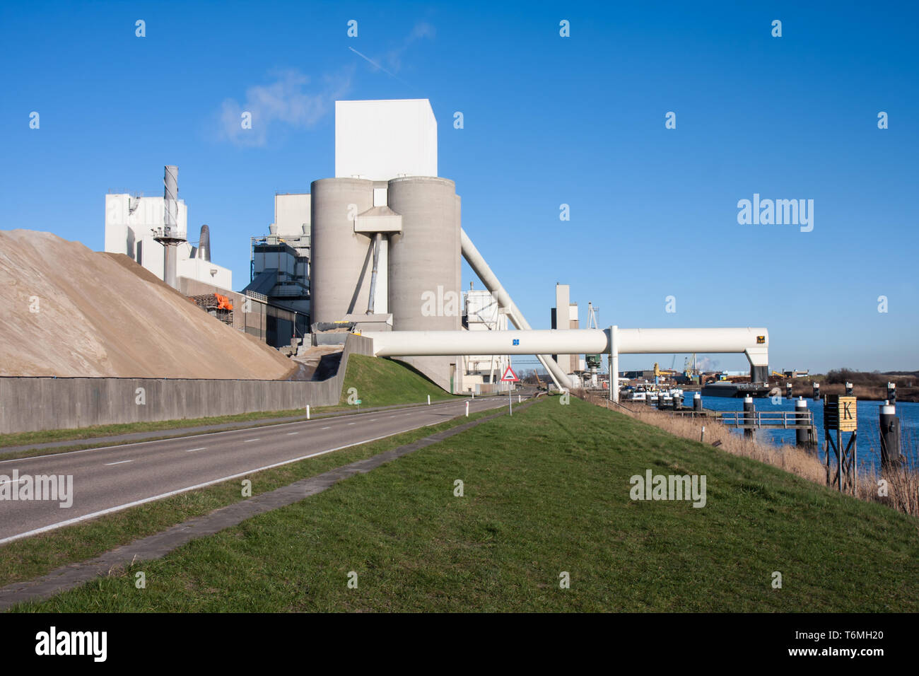 Big cement factory near a canal in the Netherlands Stock Photo - Alamy