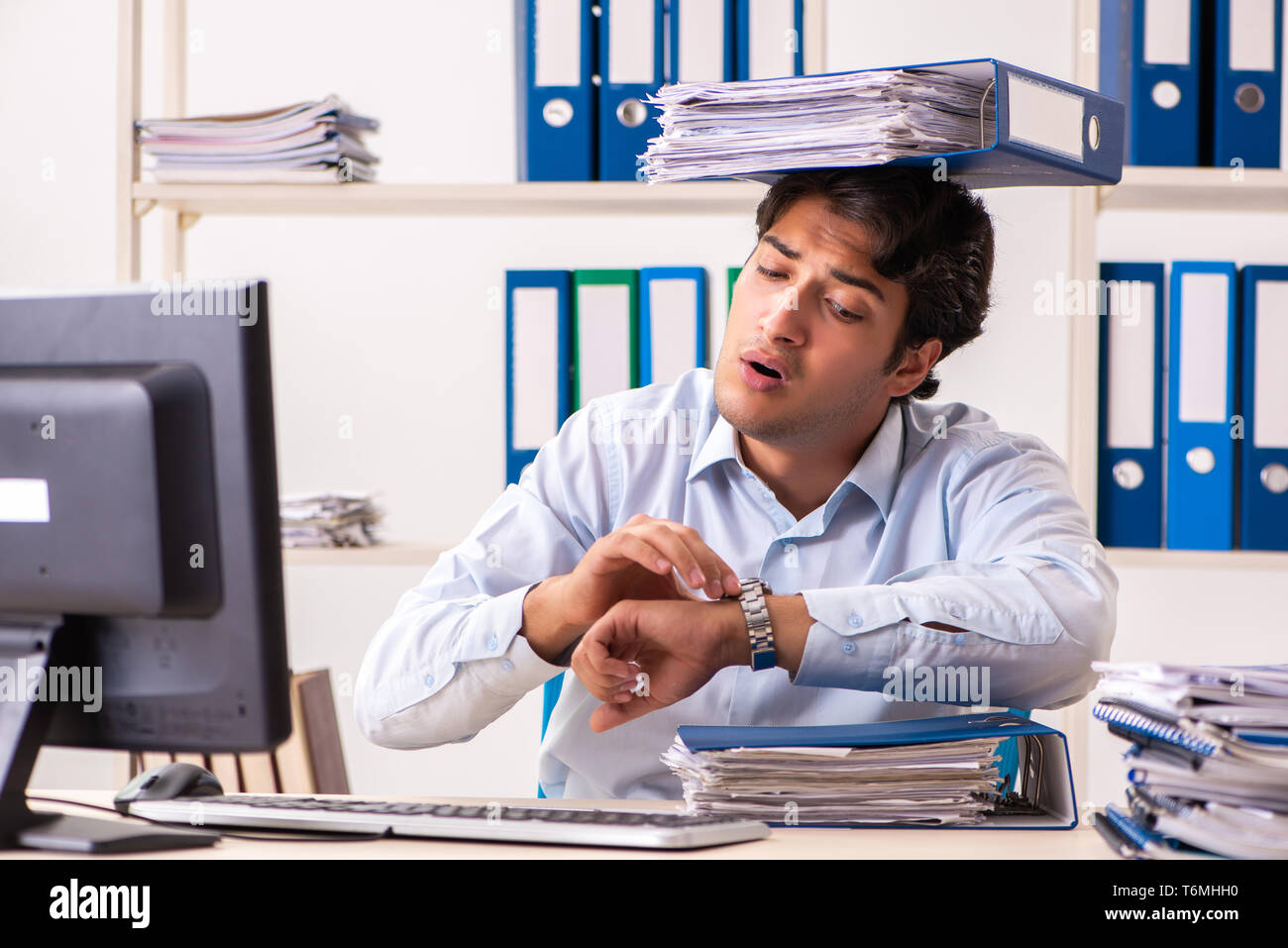 Overloaded busy employee with too much work and paperwork Stock Photo ...