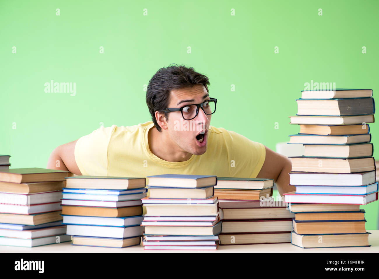 Student with too many books to read before exam Stock Photo - Alamy