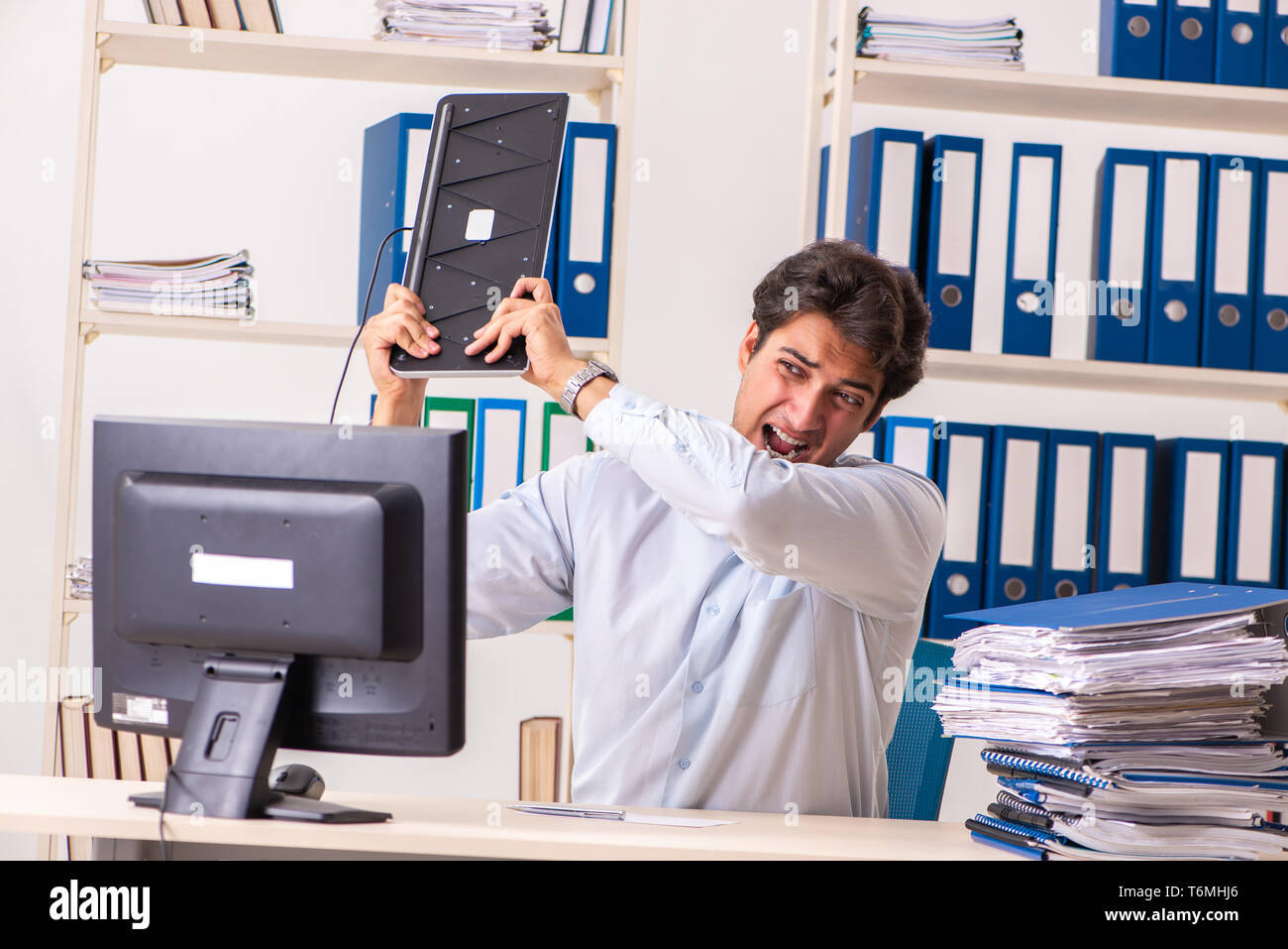 Overloaded busy employee with too much work and paperwork Stock Photo ...
