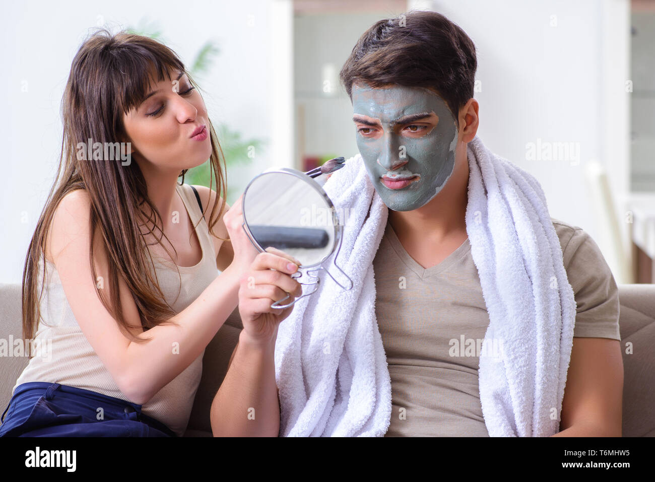 Handsome applying clay mask on face Stock Photo - Alamy
