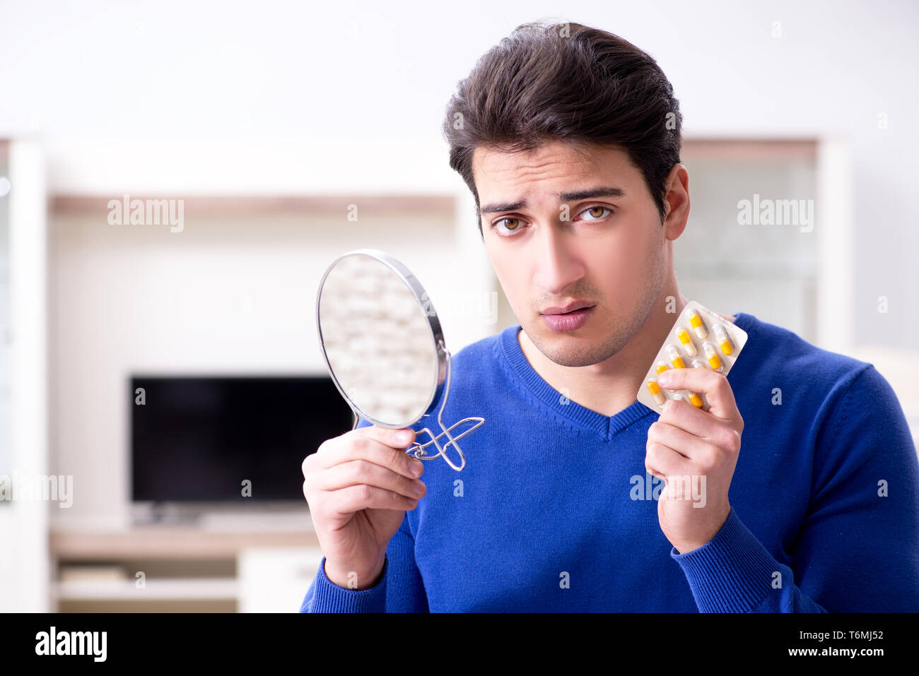 Young handsome man taking care of face skin Stock Photo - Alamy