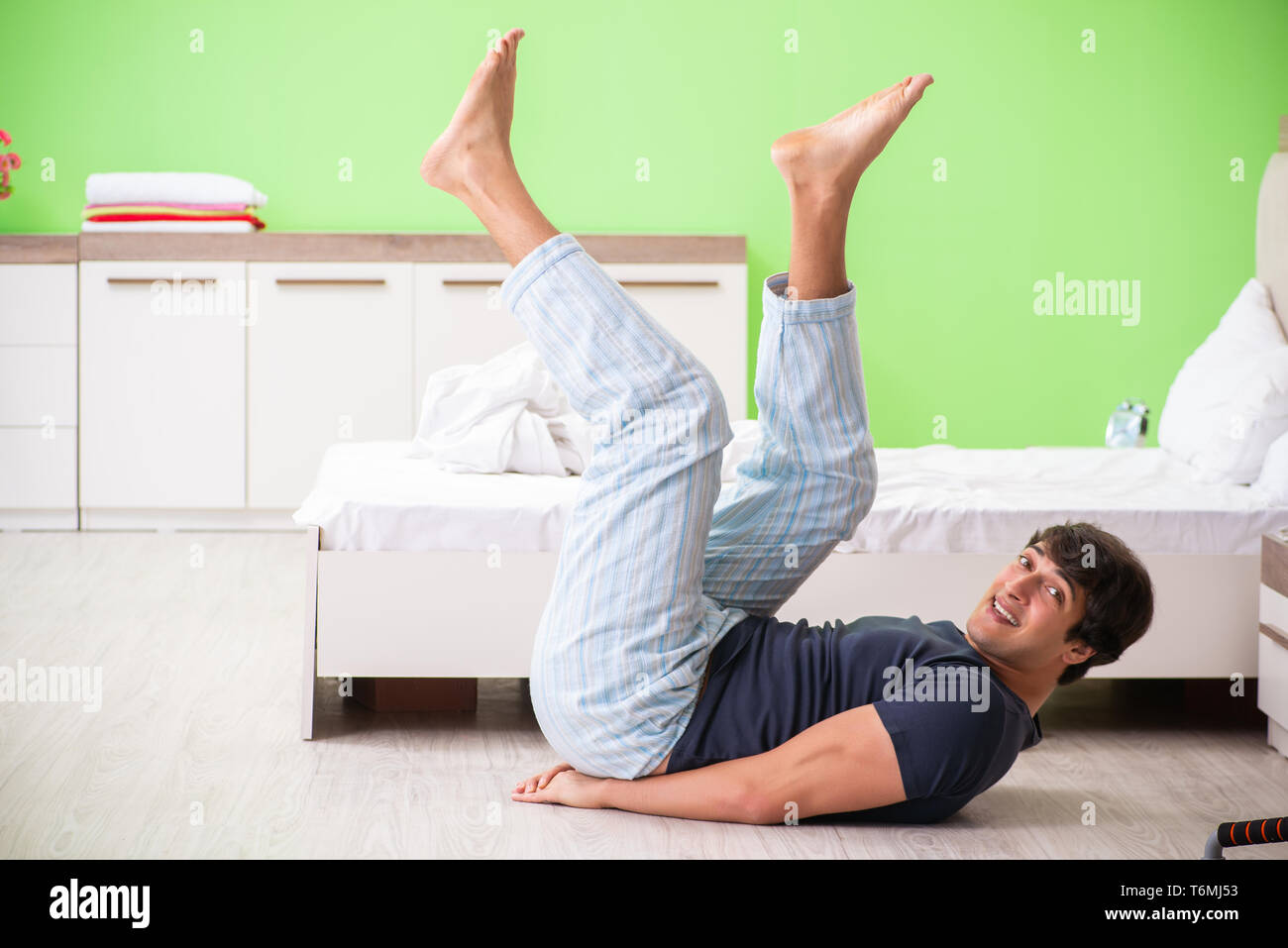 Young man in pajamas doing morning exercises Stock Photo - Alamy