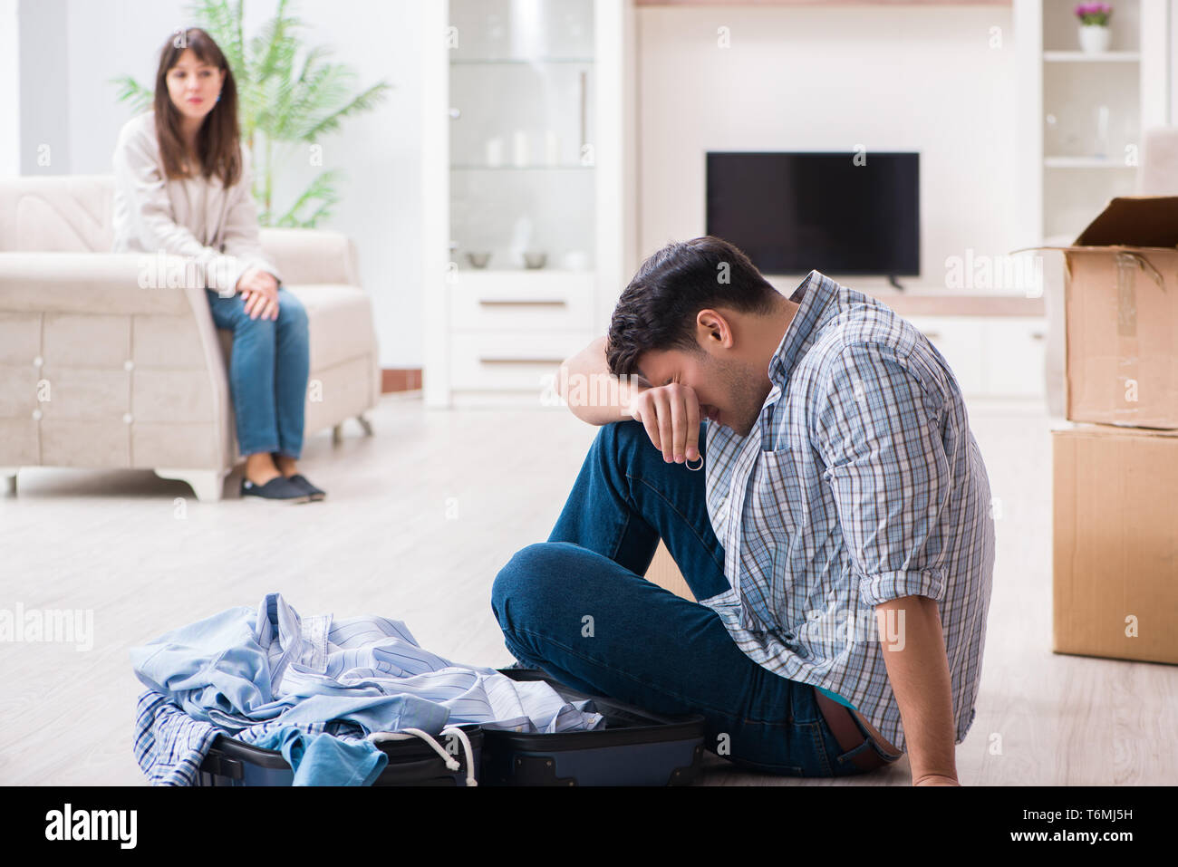 Woman evicting man from house during family conflict Stock Photo - Alamy