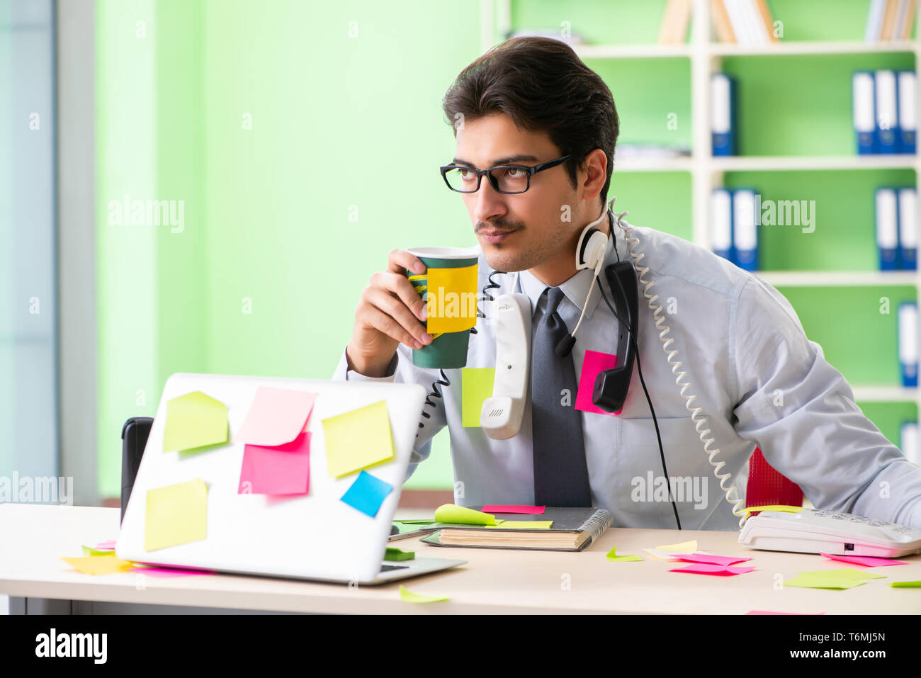 Young help desk operator working in office with many conflicting Stock ...
