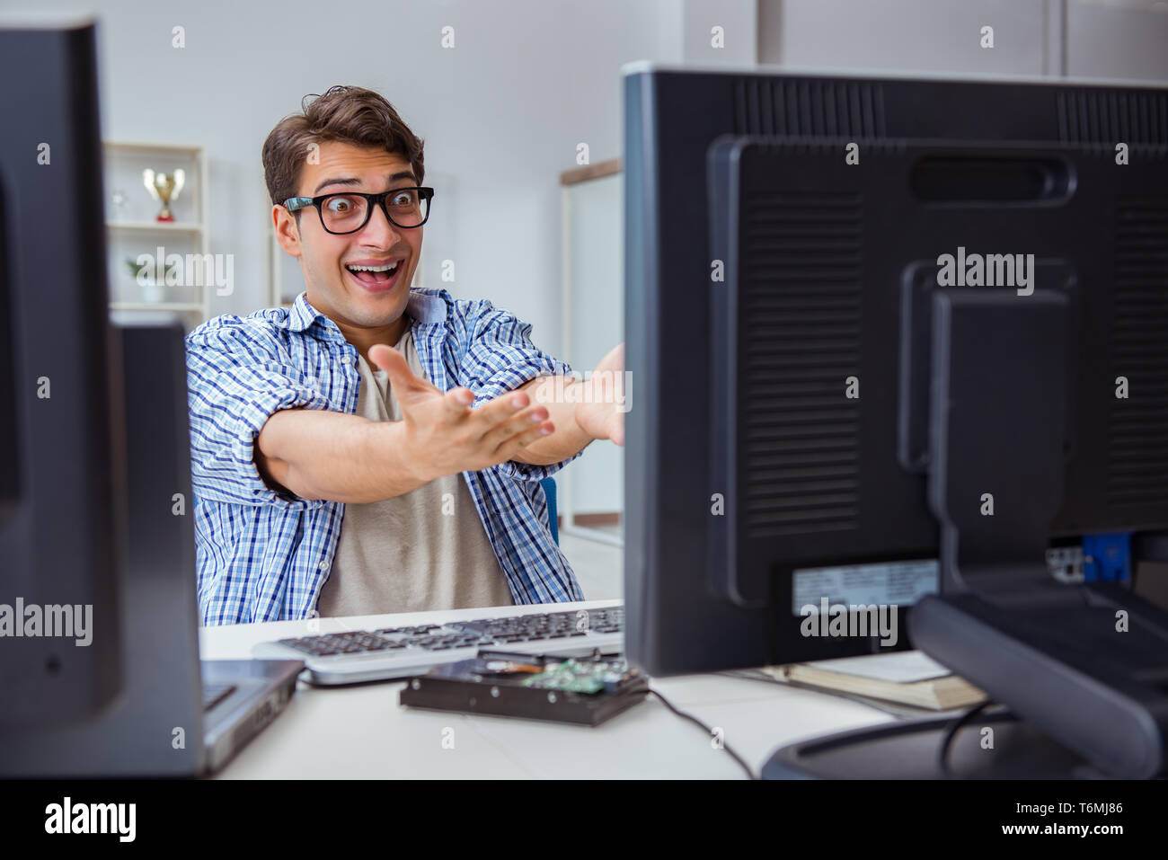 Young trader monitoring markets on screens Stock Photo - Alamy
