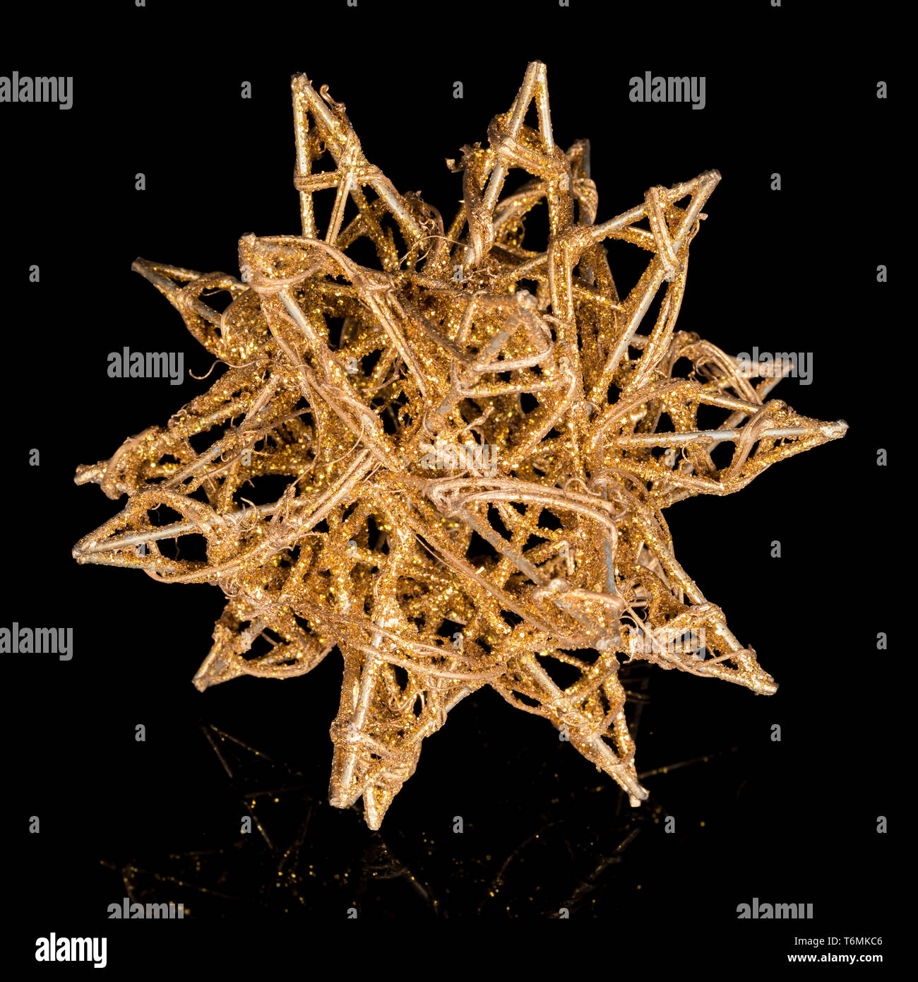 Gilded star isolated on black background Stock Photo - Alamy