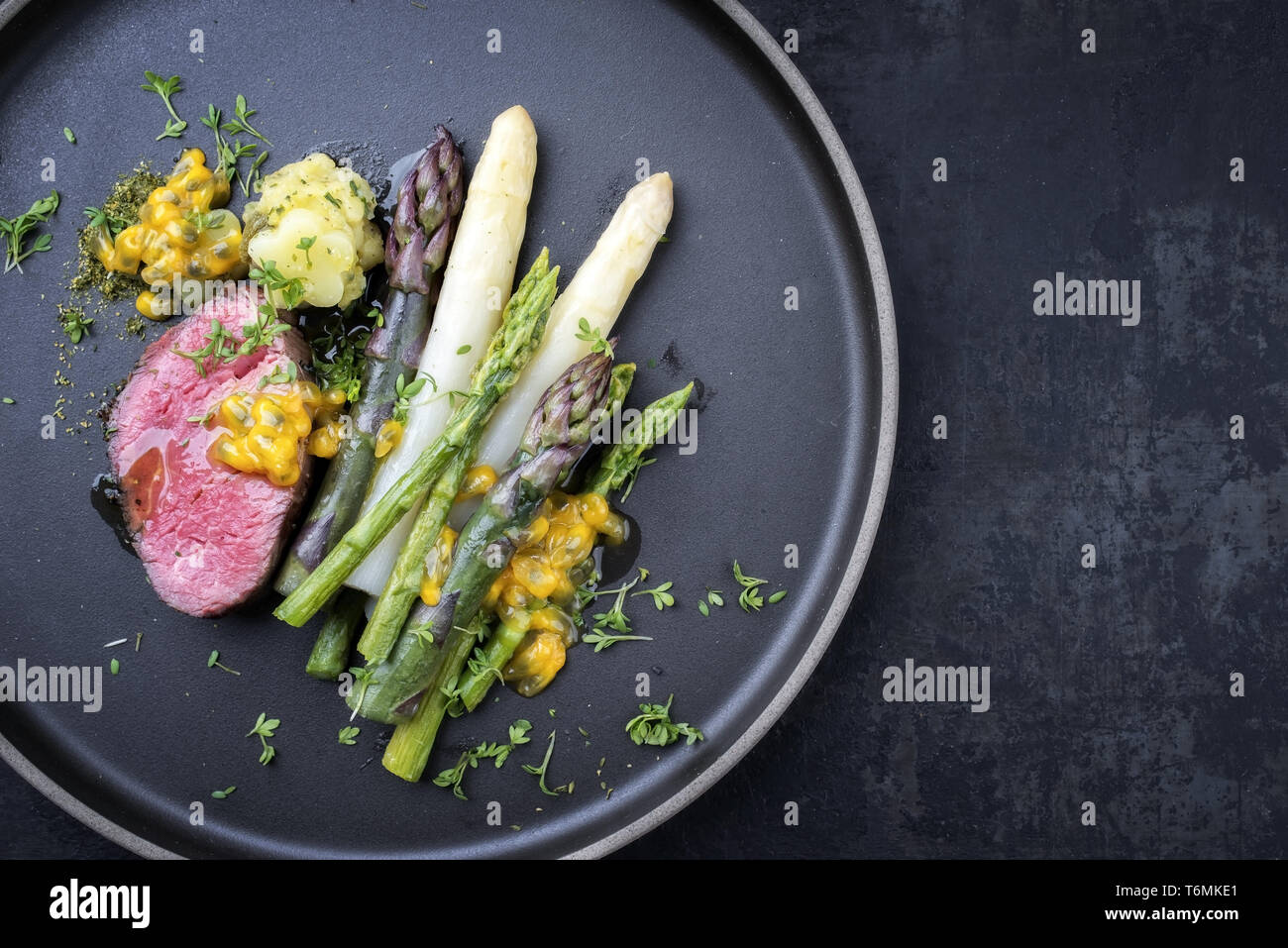 Modern German barbecue dry aged sliced fillet steak with green Stock ...