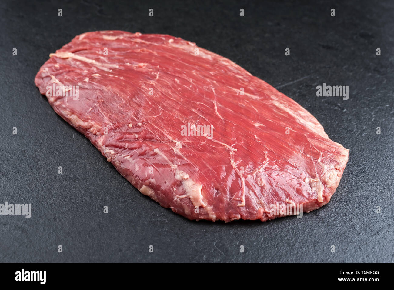 Raw dry aged wagyu flank steak as top view on a black board Stock Photo ...