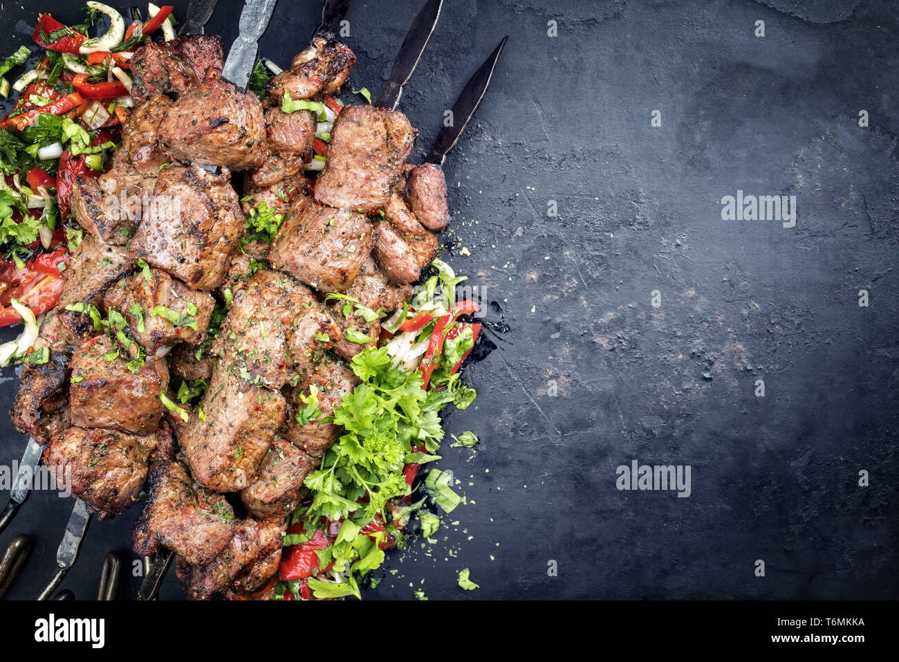 Traditional Russian shashlik on a barbecue skewer with vegetable and ...