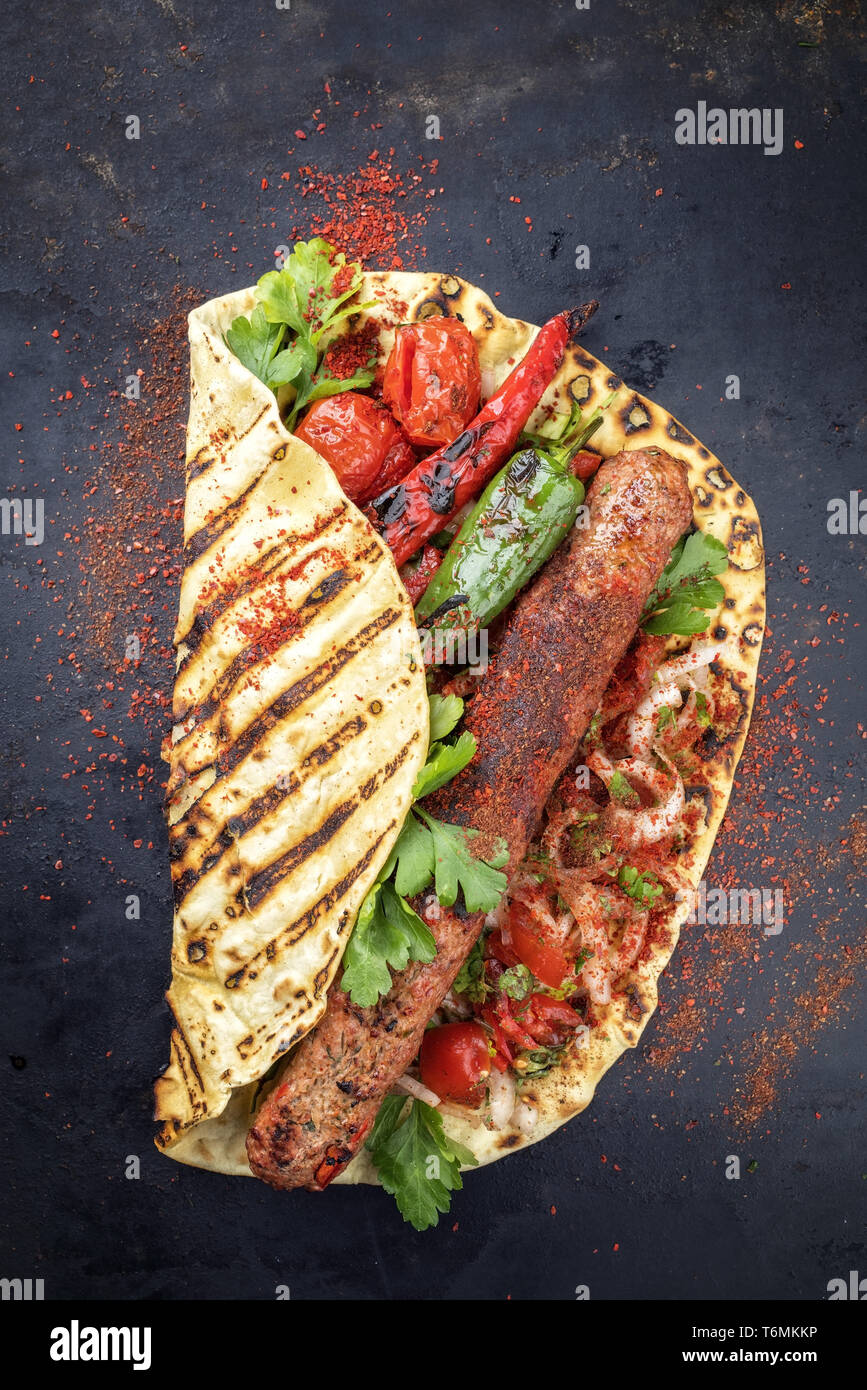 Traditional Adana Kebap with tomato and salad on a flatbread with copy ...